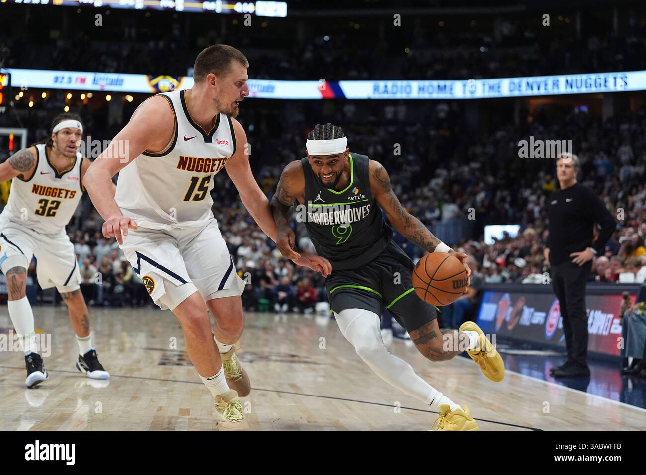 Minnesota Timberwolves guard Nickeil Alexander-Walker (9) and Denver Nuggets center Nikola Jokic ...