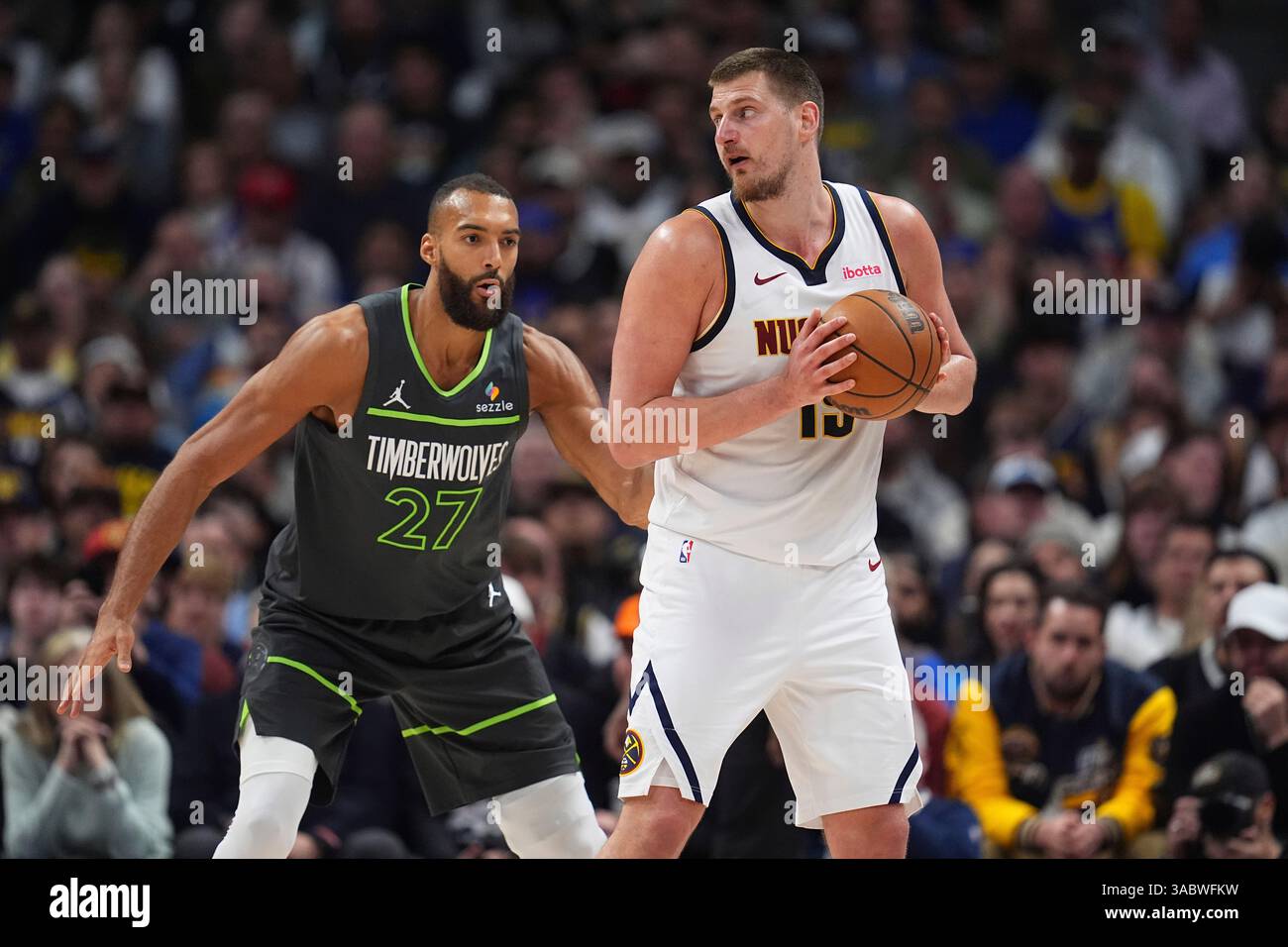 Denver Nuggets center Nikola Jokic (15) and Minnesota Timberwolves center Rudy Gobert (27) in ...