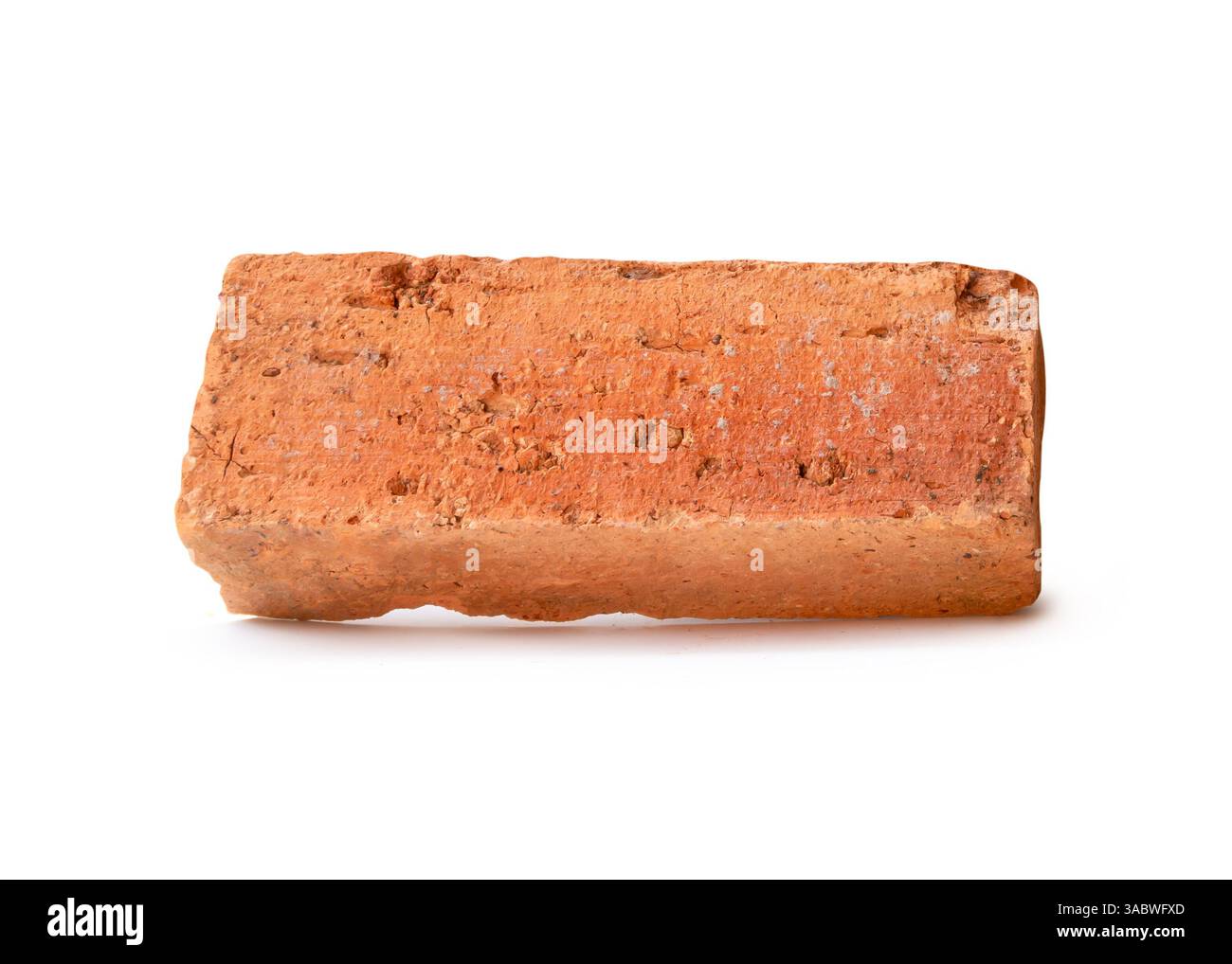 Side view of single cracked old red or orange brick is isolated on ...