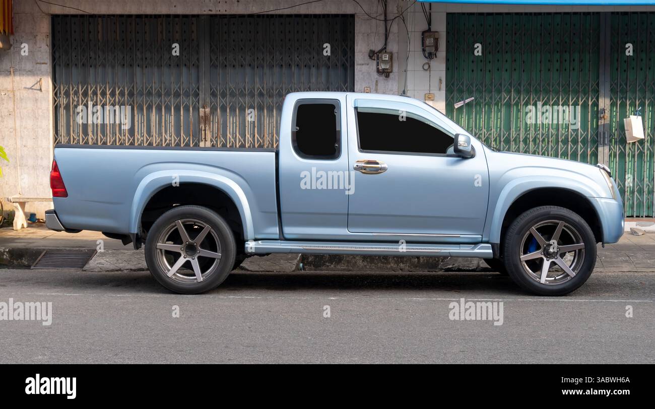 Right side view of single light blue pickup truck is parking on city ...