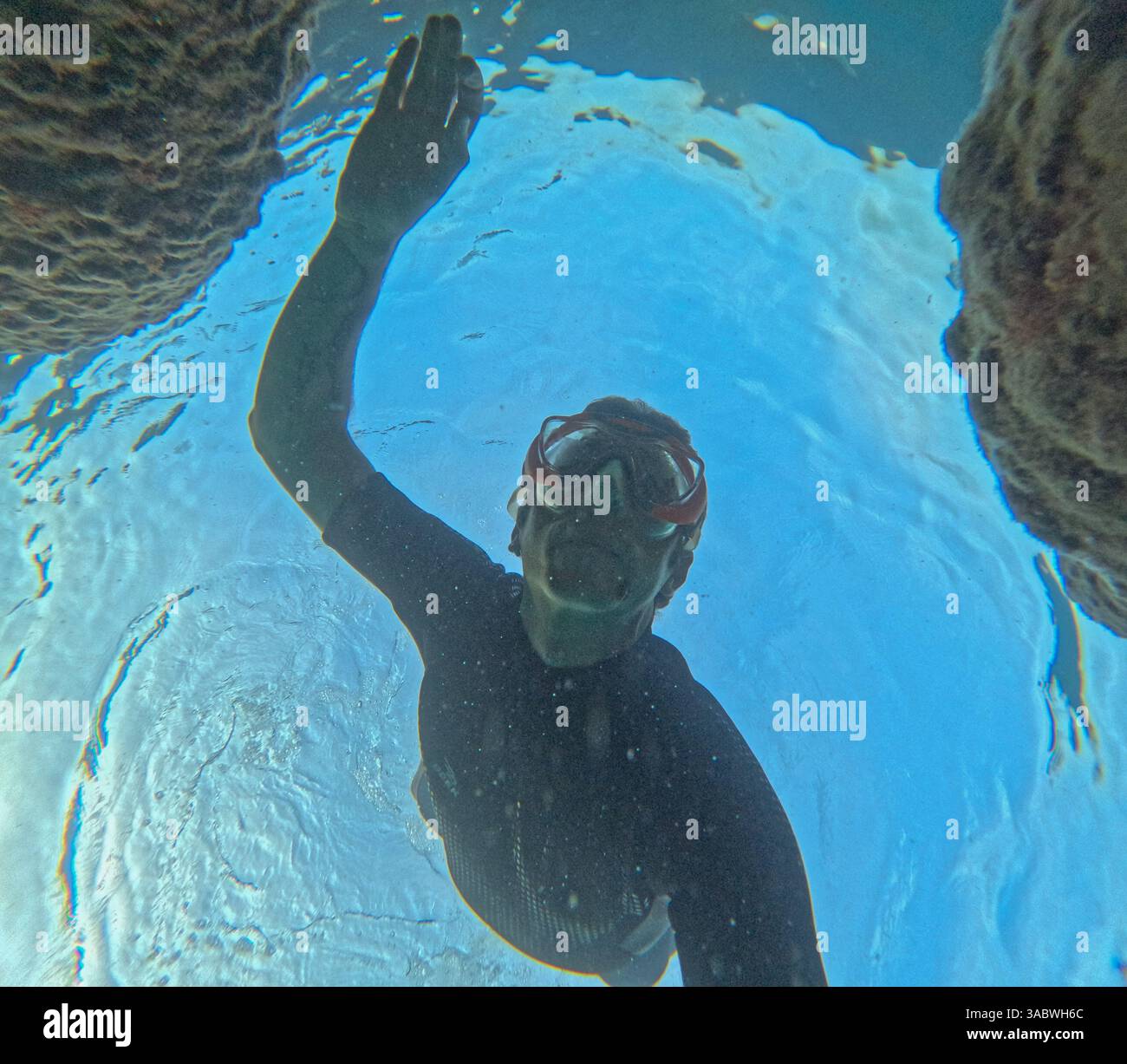 Italian man swimming underwater in the Mediterranean off sicilian coast ...