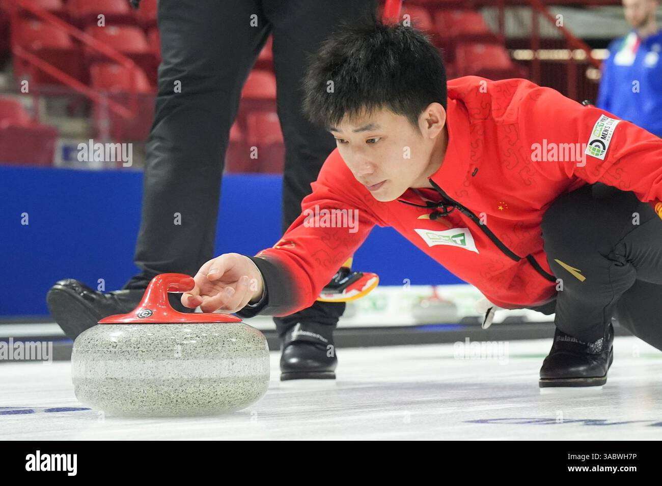 China's Xueqing Fei throws a stone against Czechia at the World Men's ...