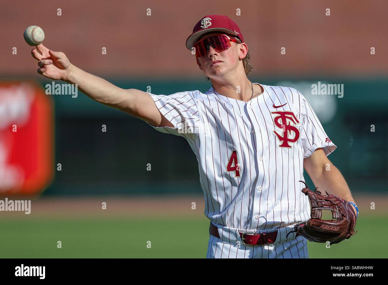 Florida State infielder Cal Fisher (4) warms up before an NCAA baseball ...