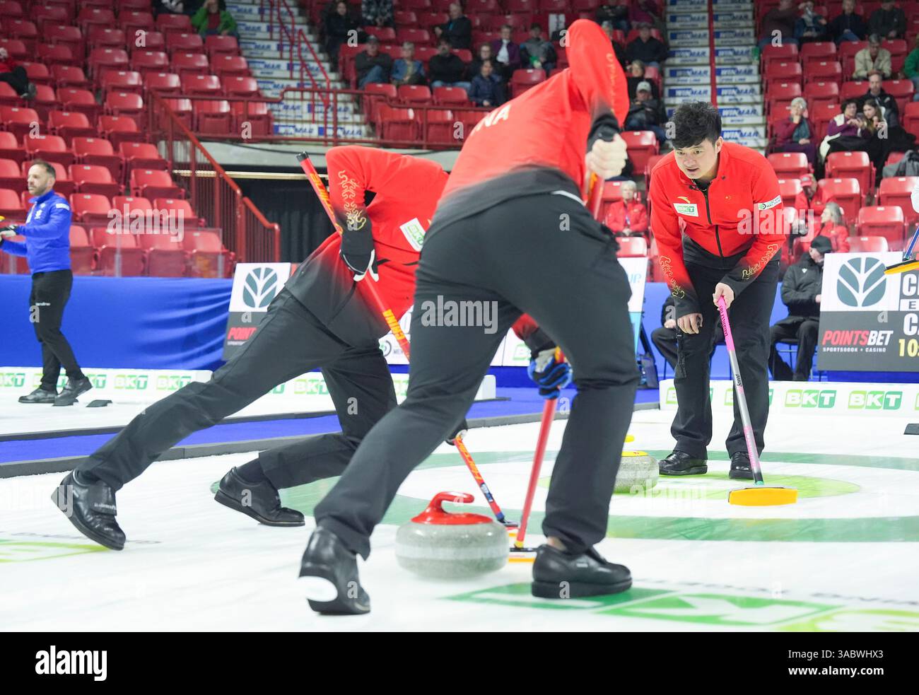 China's skip Xiaoming Xu, right, keeps a close eye as Zhiyu Wang (left ...