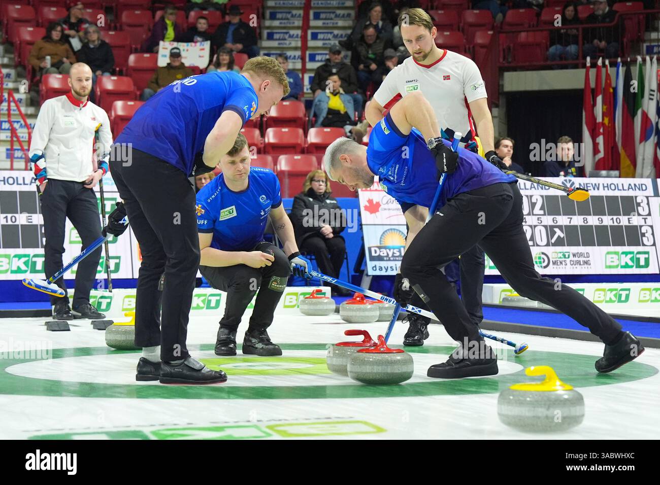 Scotland's Hammy McMillan, front right, sweeps the stone into the house ...