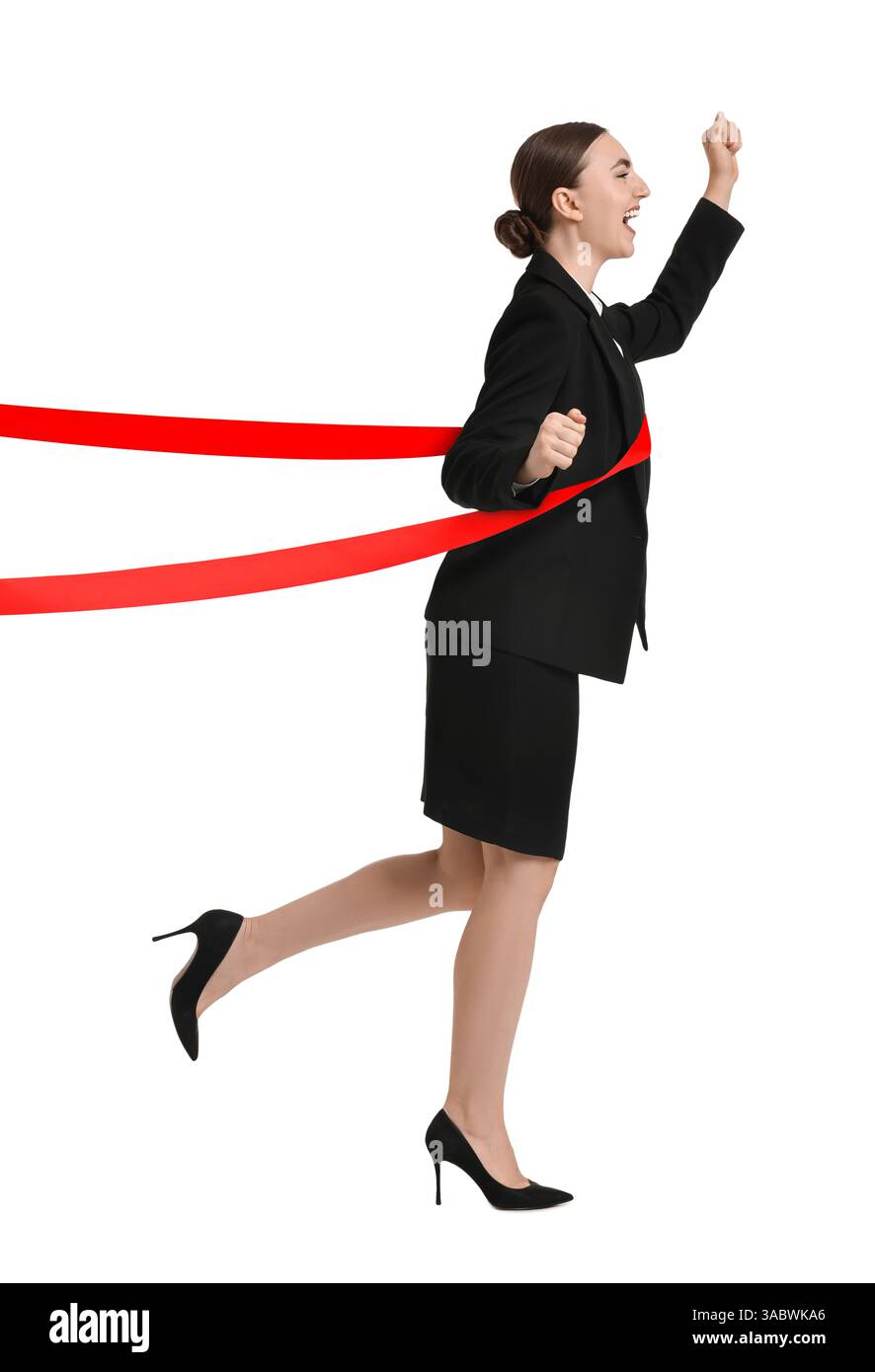 Happy businesswoman crossing red finish line ribbon on white background ...