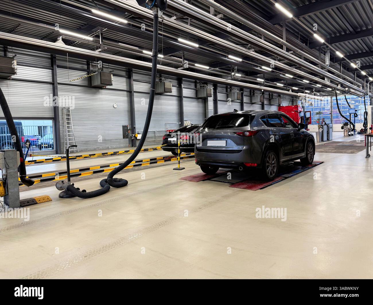 Modern cars undergoing procedure of vehicle inspection at station Stock ...