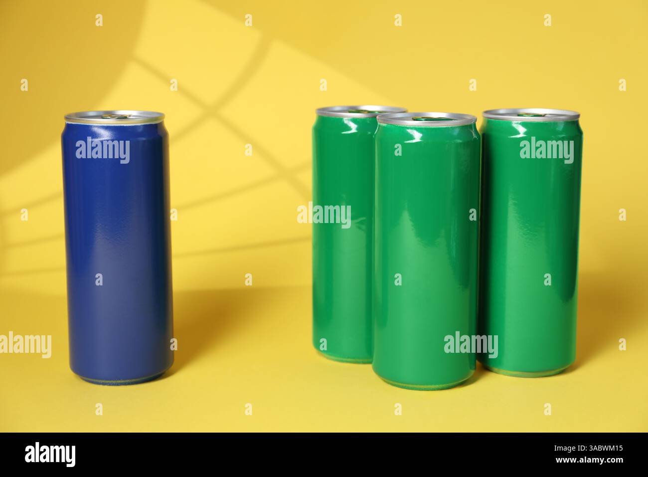 Many tin cans on yellow background with shadow Stock Photo - Alamy