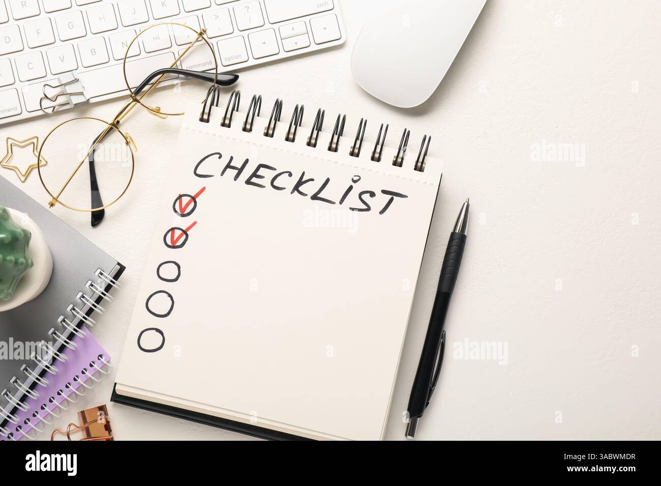 Checklist with marked checkboxes, different stationery, glasses ...