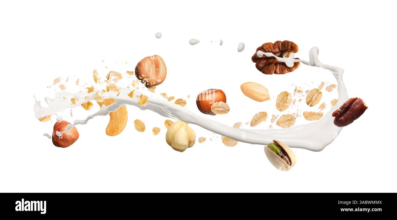 Oat flakes, nuts and splashing milk in air on white background. Banner ...