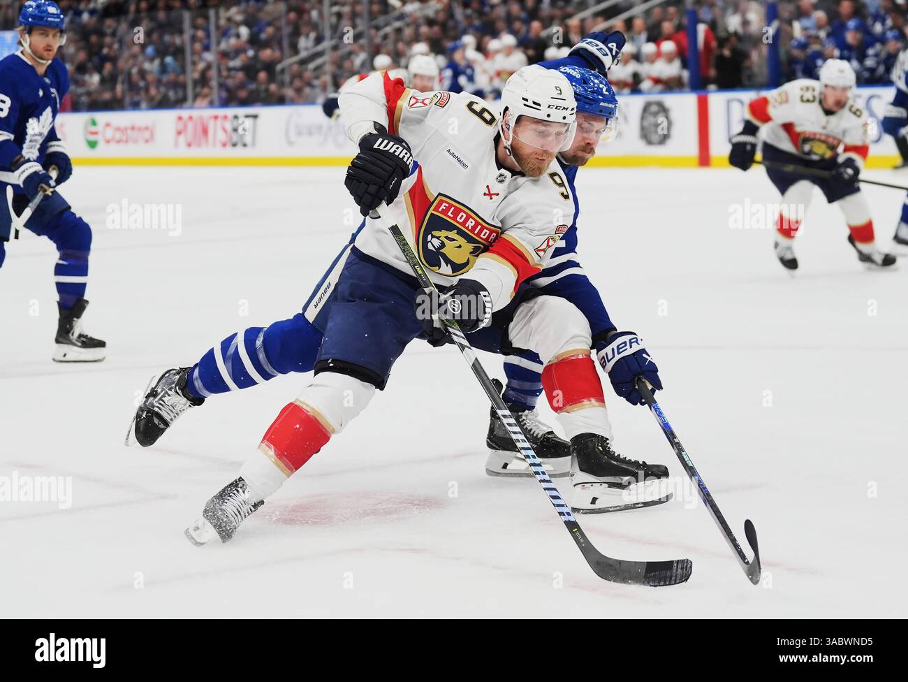Florida Panthers' Sam Bennett (9) protects the puck from Toronto Maple ...