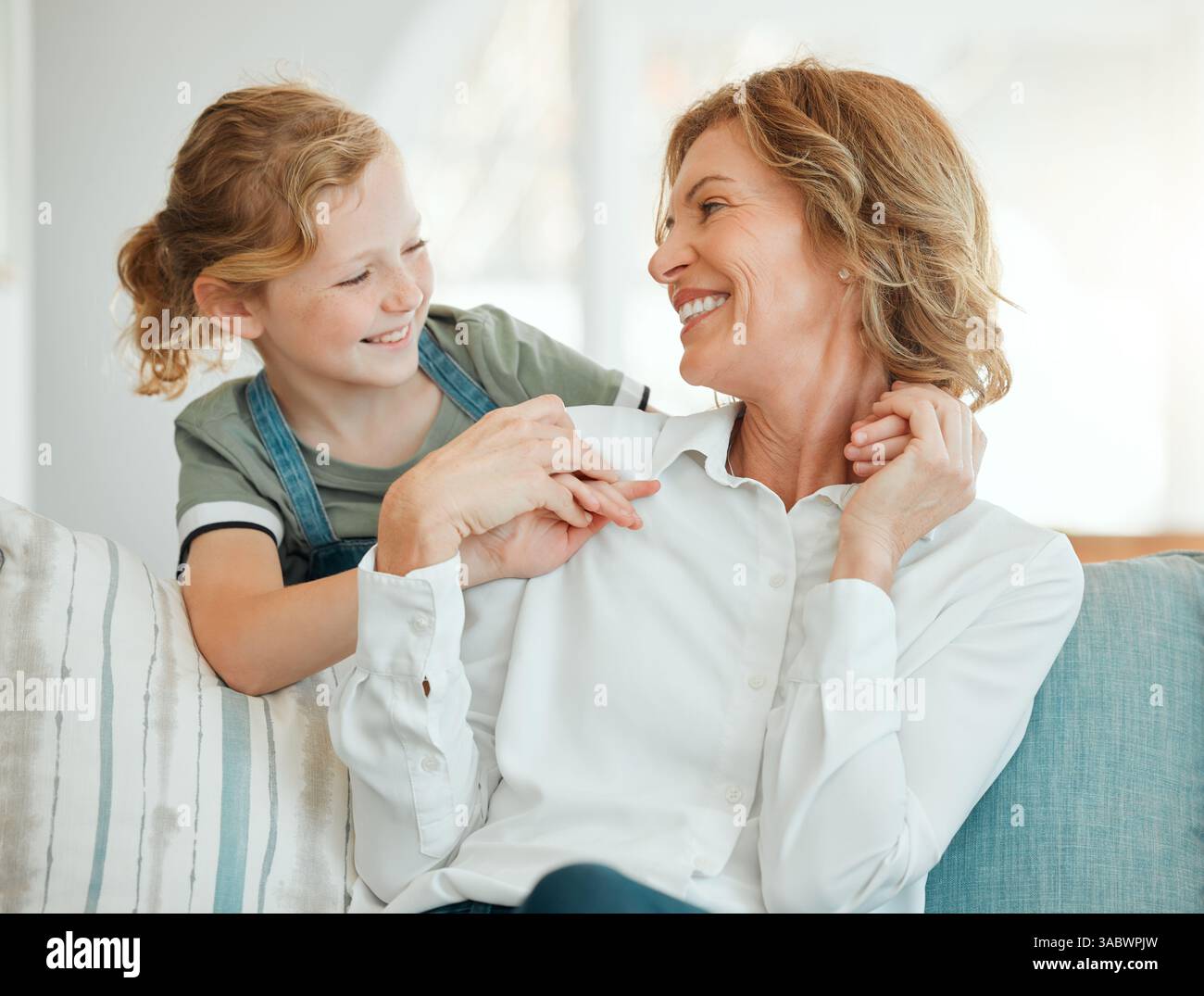 Girl, grandmother and relax on sofa with smile for bonding, care and ...