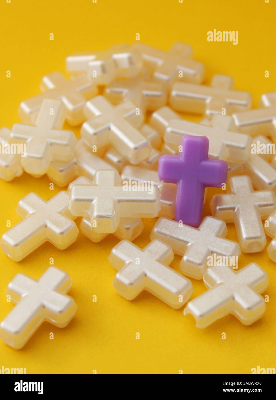 Purple cross on a group of pearly white crosses - vertical format Stock ...