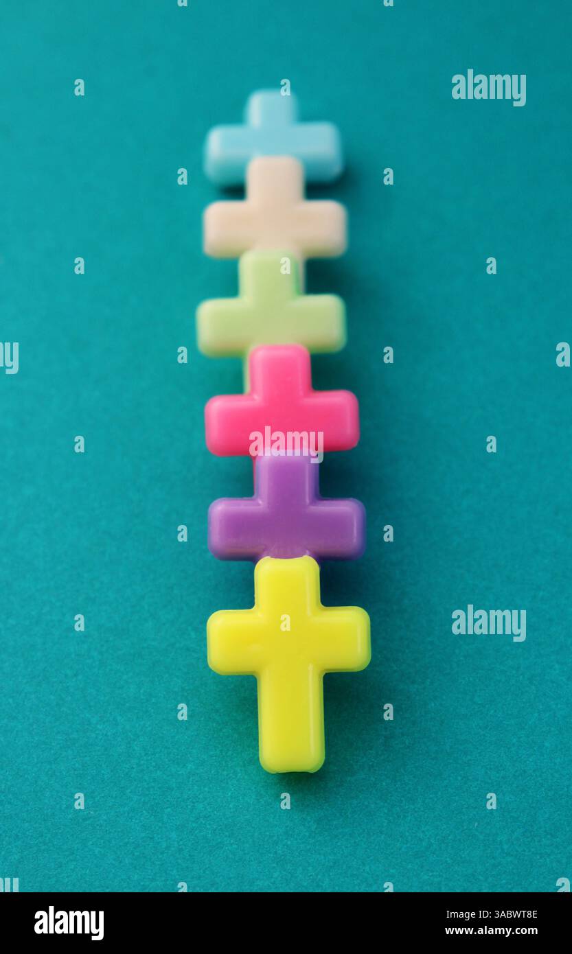 Crosses of different colors leaning on top of each other in a row ...