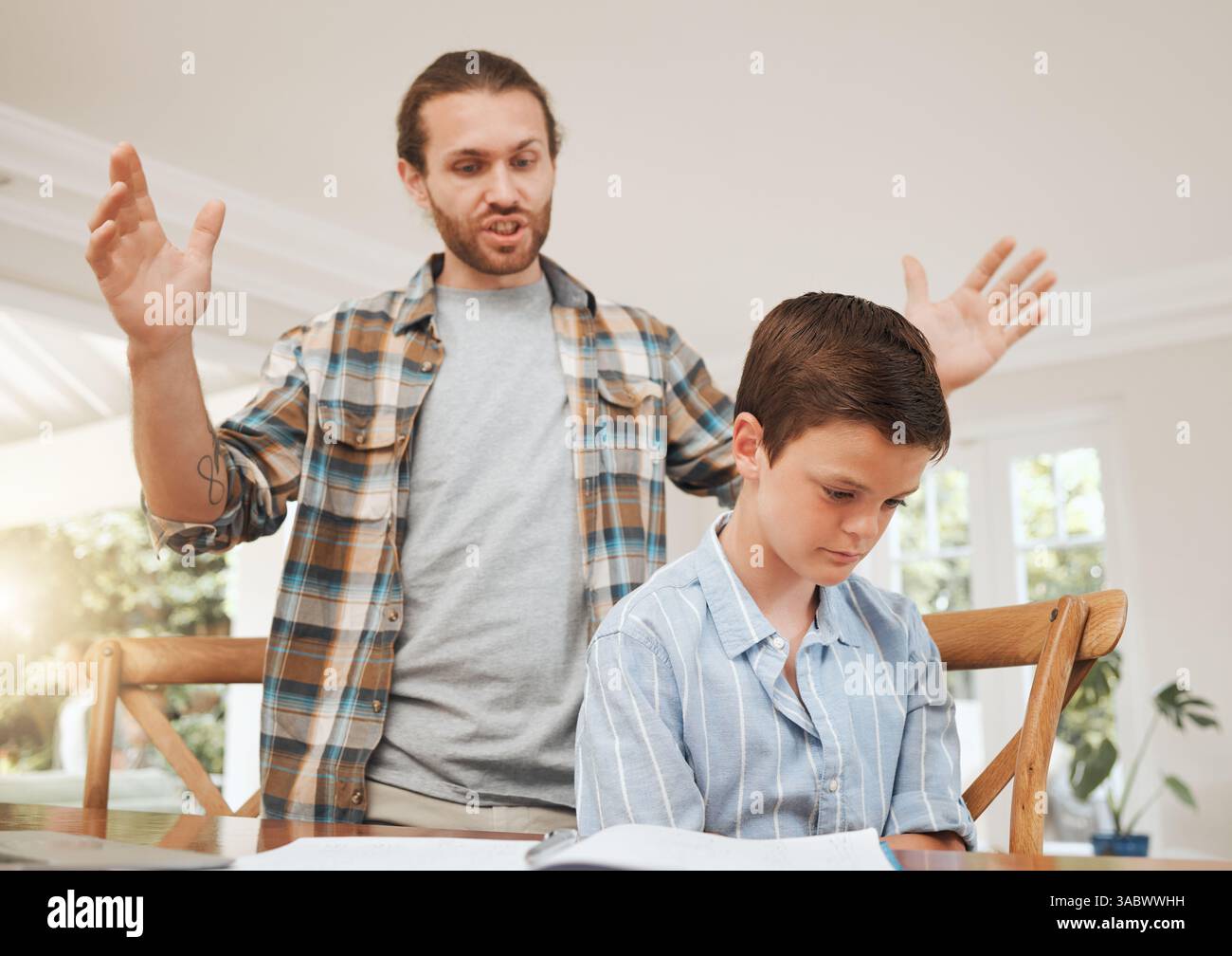 Frustrated kid sitting table parents hi-res stock photography and ...