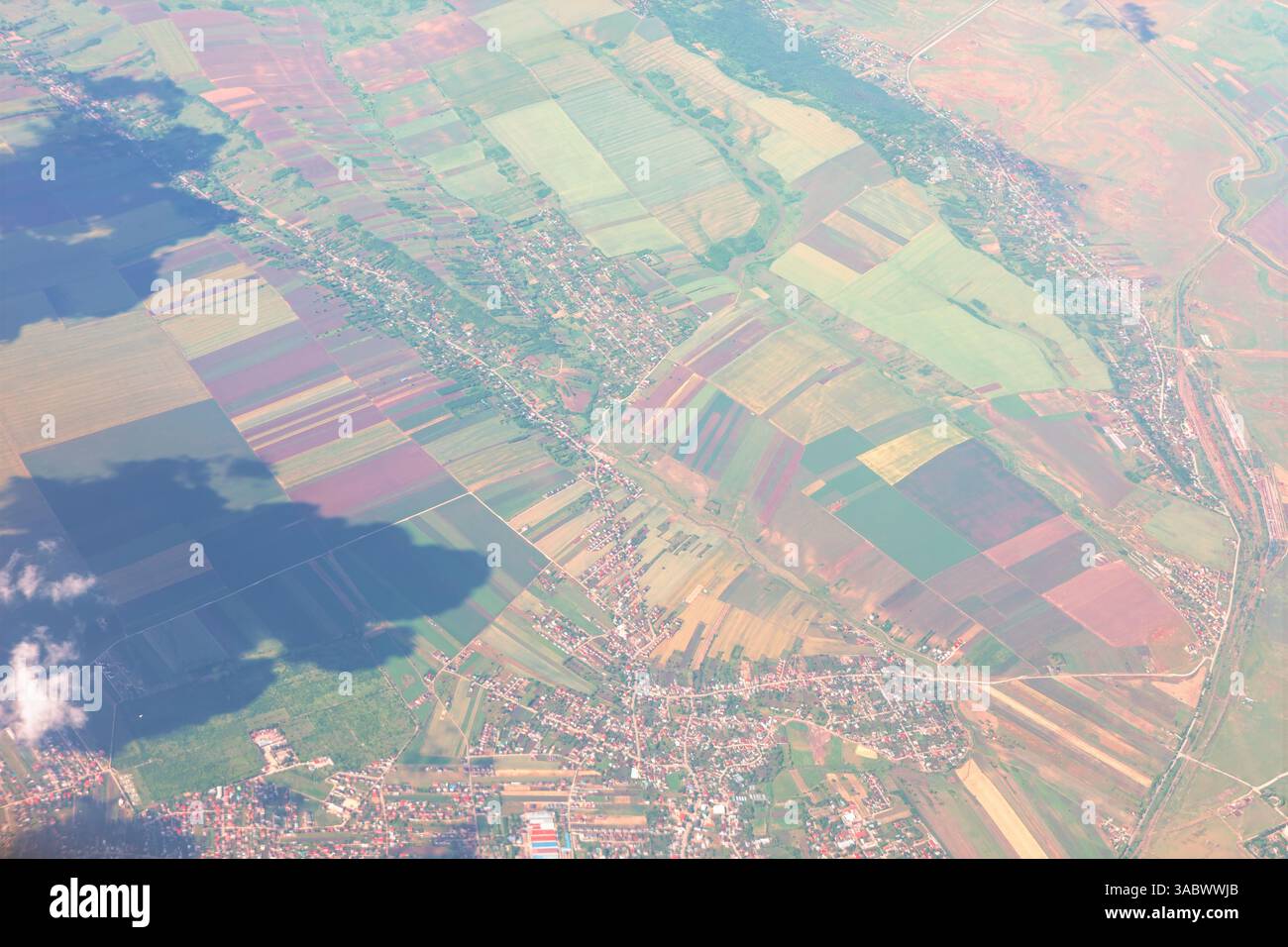 Aerial view of rural landscape showcases patchwork fields, winding ...