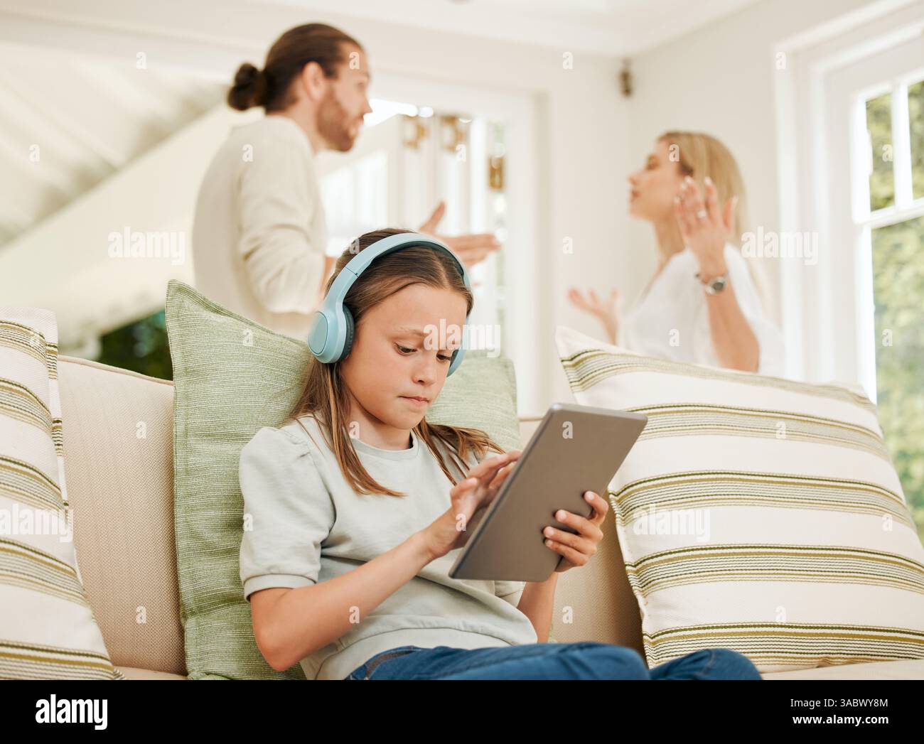 Child, tablet and parents fight in home with headphones, streaming ...