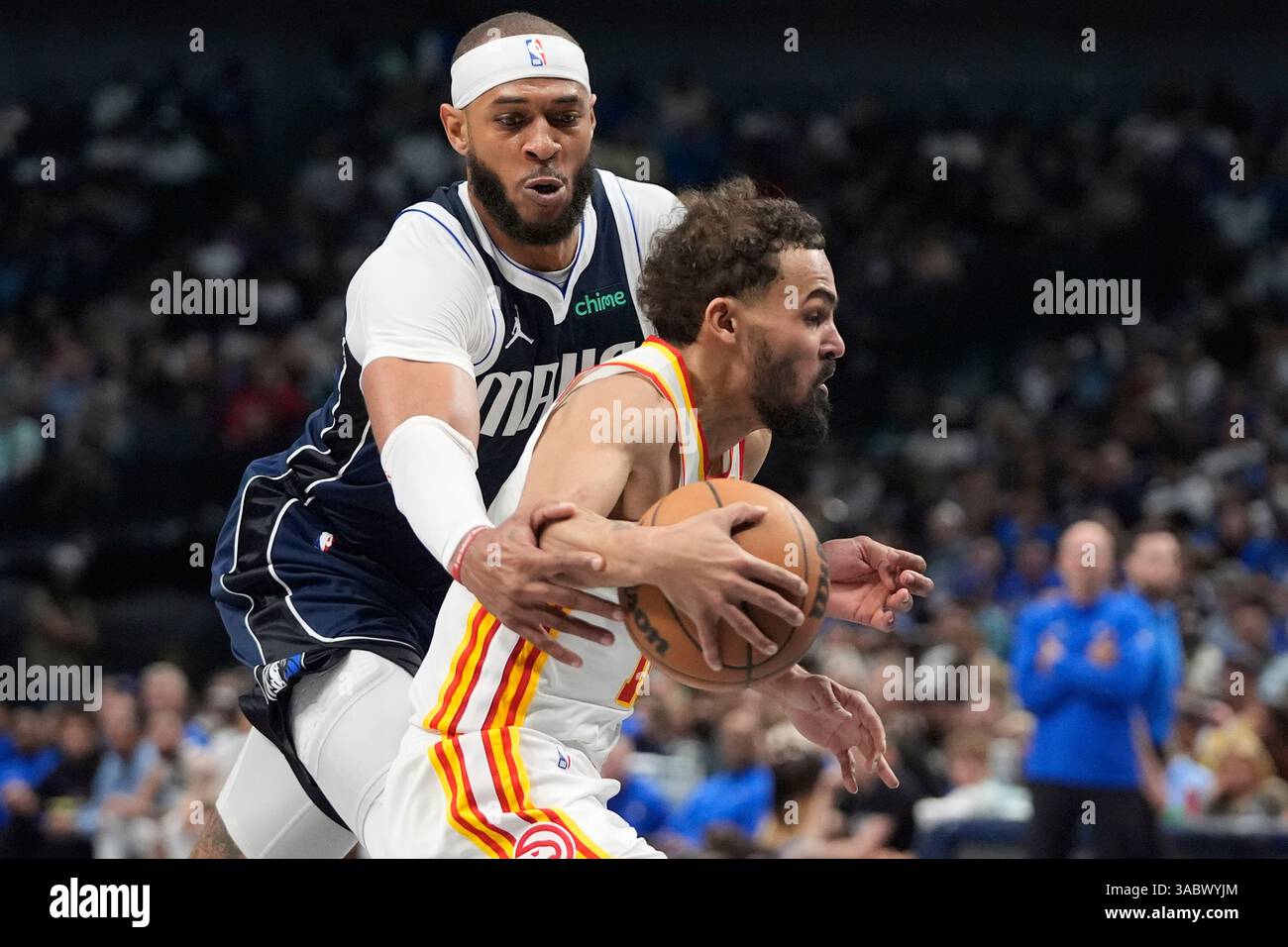 Atlanta Hawks guard Trae Young, right, is fouled by Dallas Mavericks ...