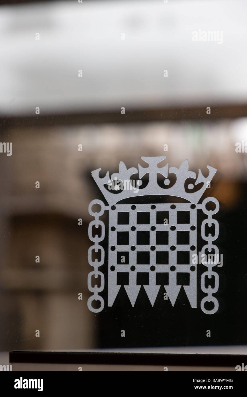 The UK Parliament emblem emblazoned on a window within the Houses of ...