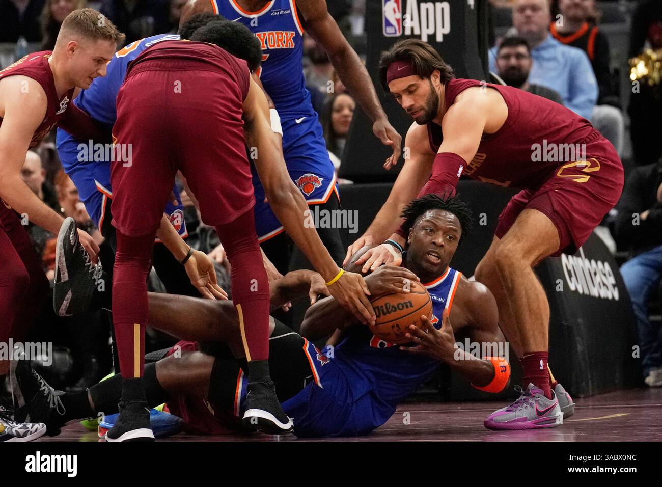Cleveland Cavaliers center Jarrett Allen, second from left, and guard Max Strus, right, reach ...