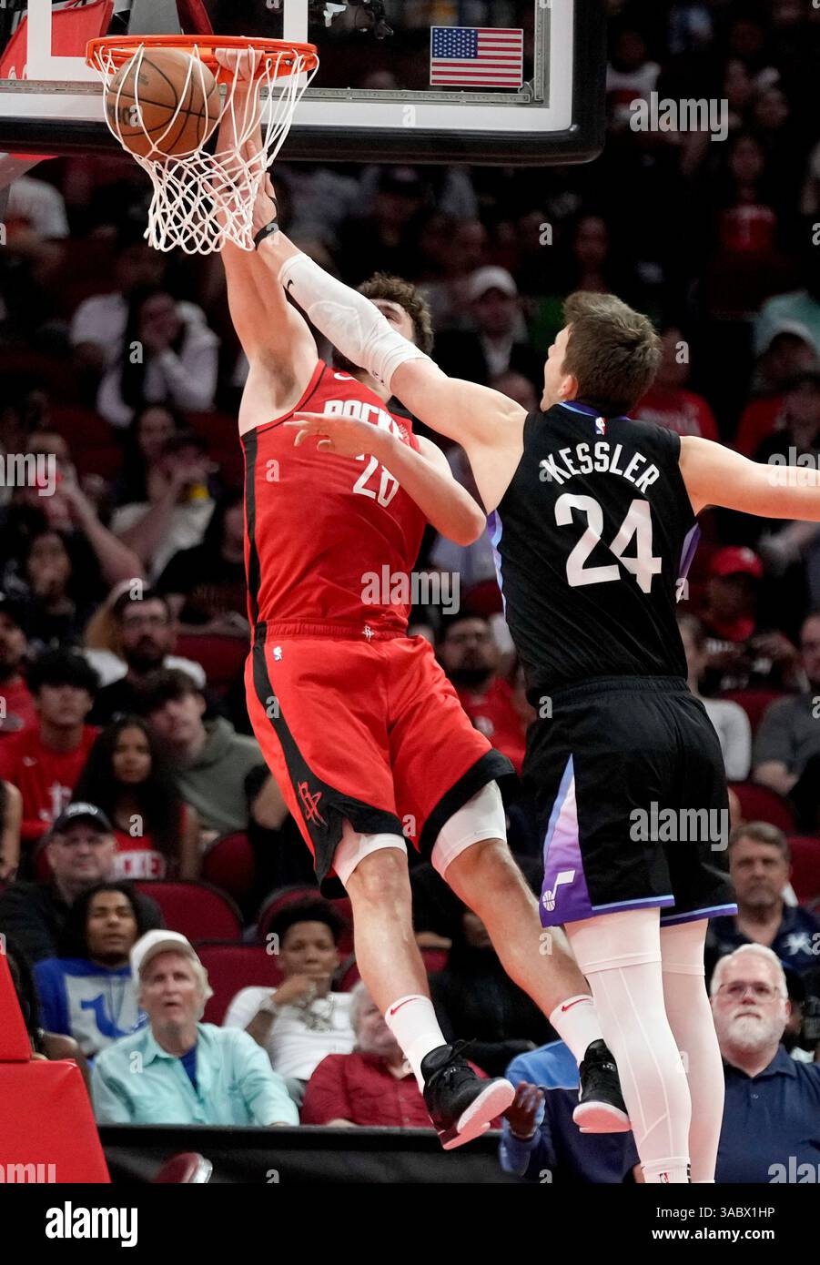 Houston Rockets center Alperen Sengun, left, dunks as Utah Jazz center ...