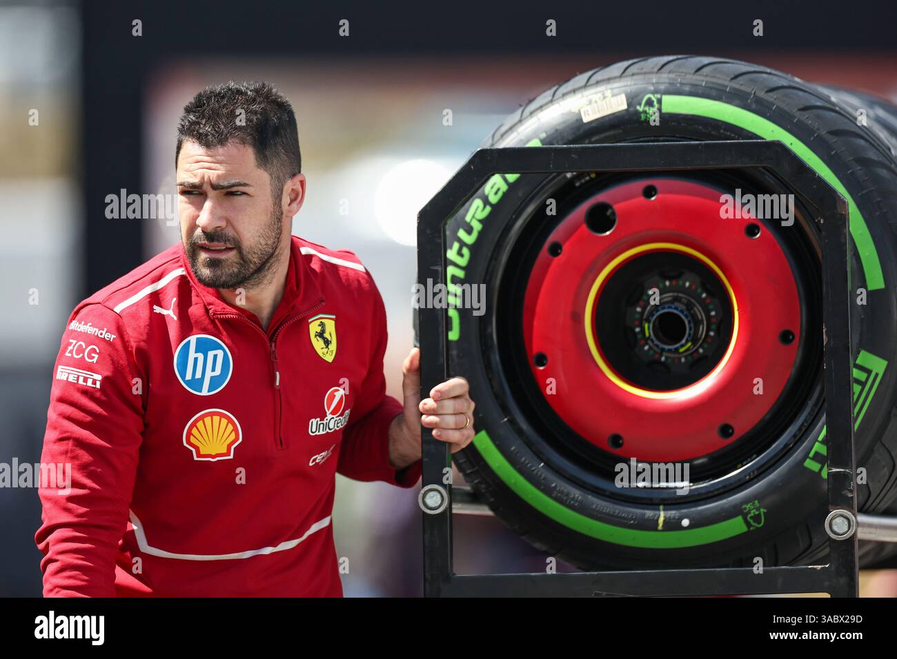 SUZUKA, JAPAN - APRIL 3: A Ferrari Mechanic moves the tyre trolley ...
