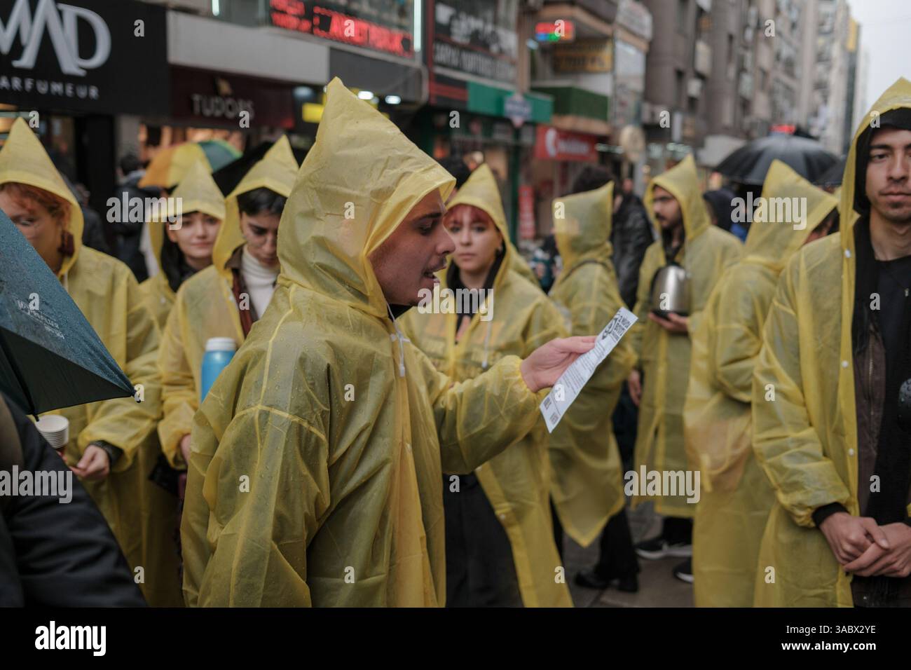 Izmir, Turkey. 02nd Apr, 2025. A young man reads a leaflet during the ...