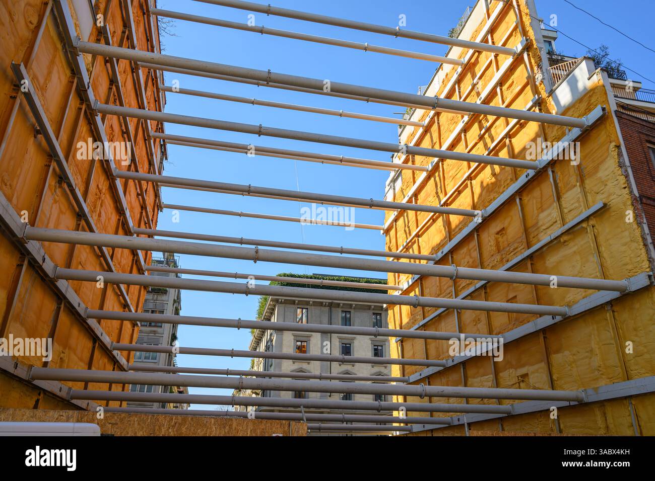Metal pipe supports between two buildings – Milan, Italy – 03 March ...