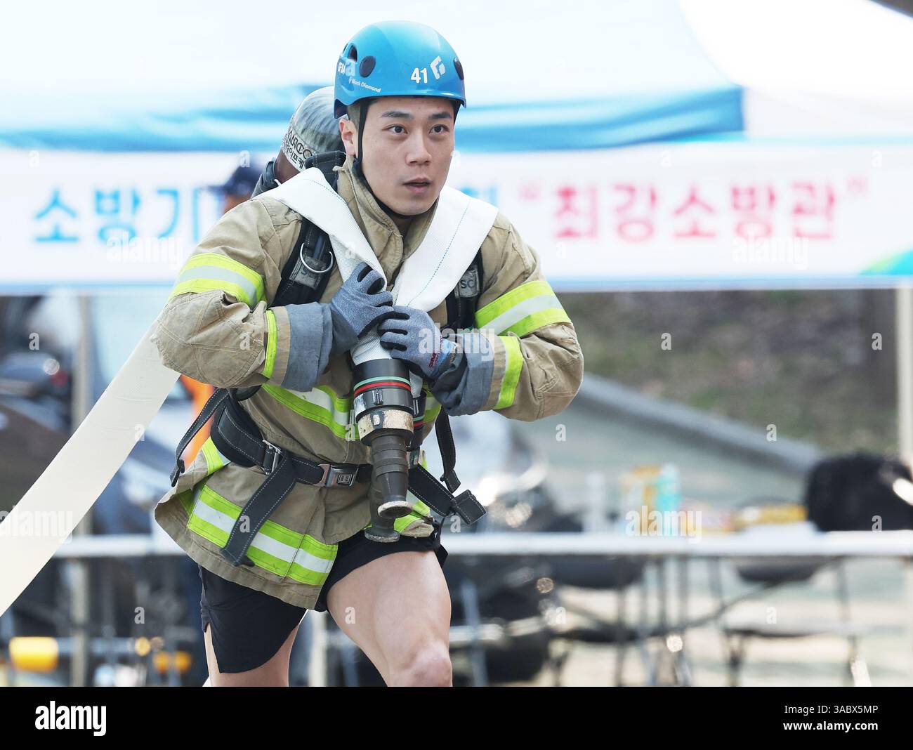 03rd Apr, 2025. Firefighter contest A firefighter carrying two fire ...
