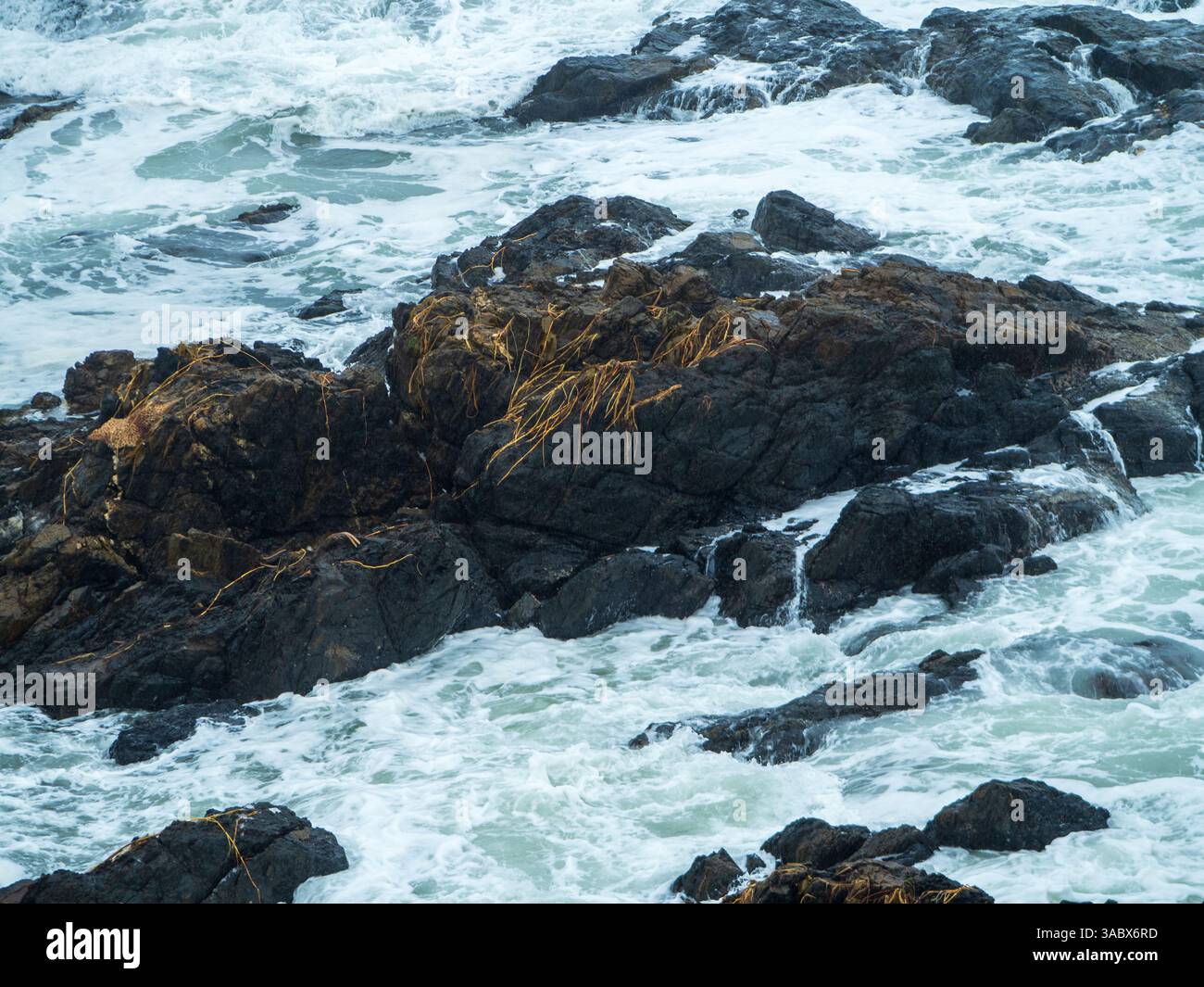 Hazardous surf, wild waves and high tides crashing over rocks leaving ...