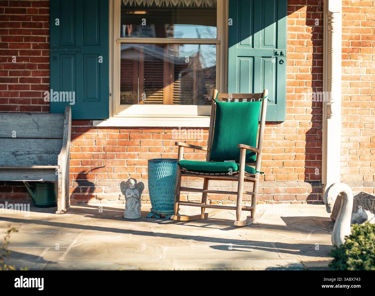 A green rocking chair on the terrace of a house in Doylestown ...