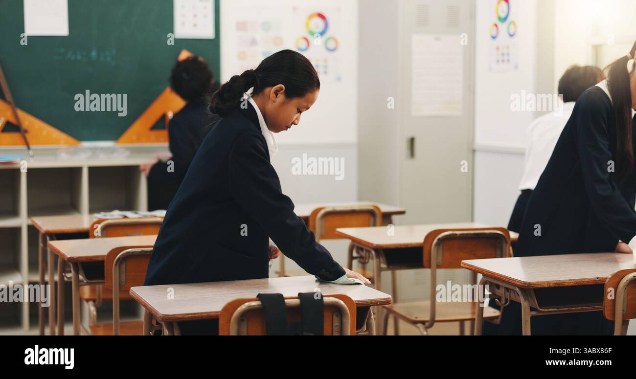 Student, child and cleaning desk at school for hygiene, learning ...