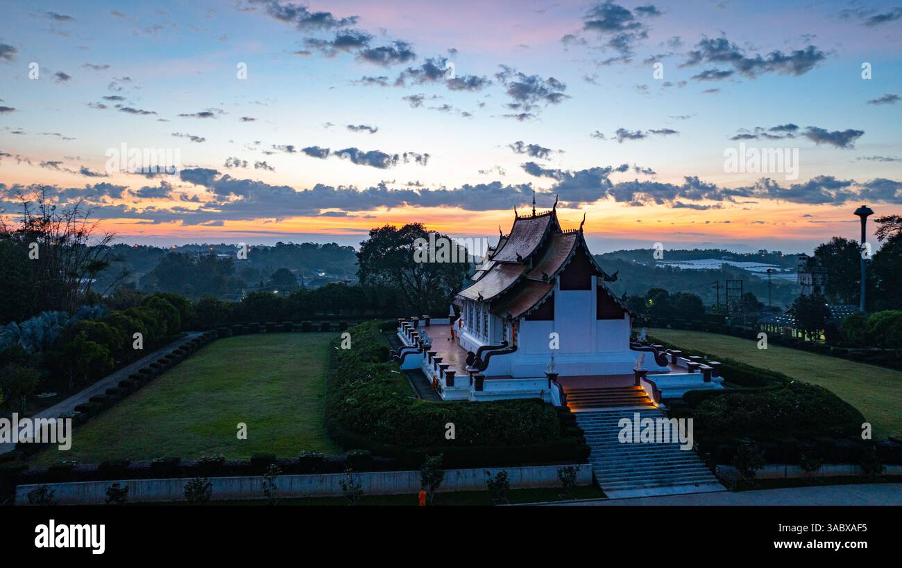 Aerial view of a traditional temple surrounded by greenery under a ...