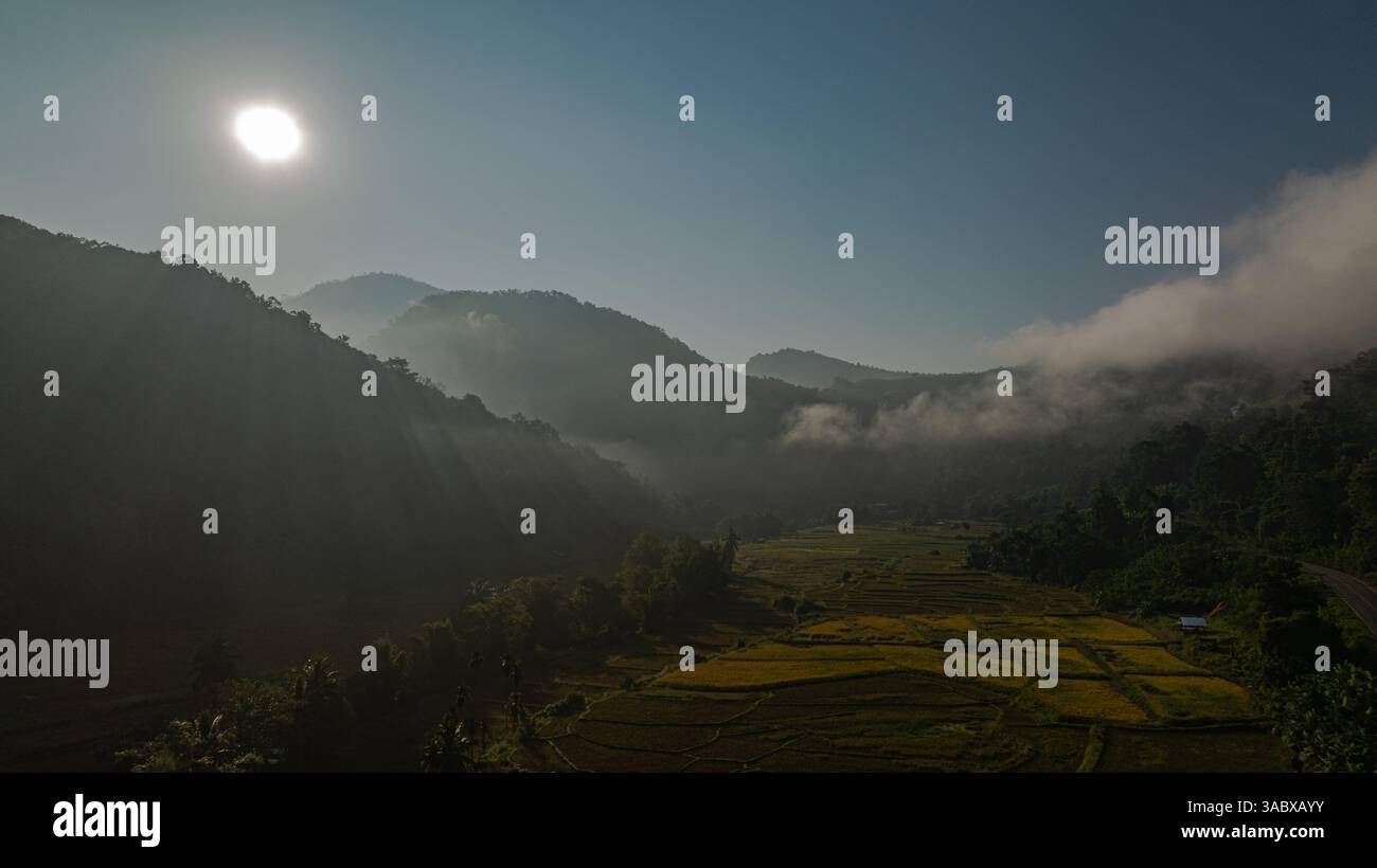 Aerial view of the sun above The sun over the mountain peaks shines ...