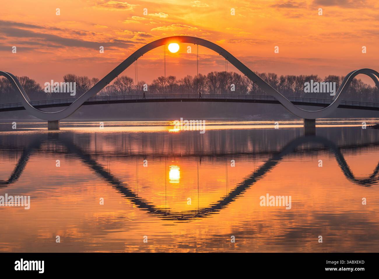 A breathtaking sunrise over a pedestrian bridge in Kyiv, Ukraine. The ...