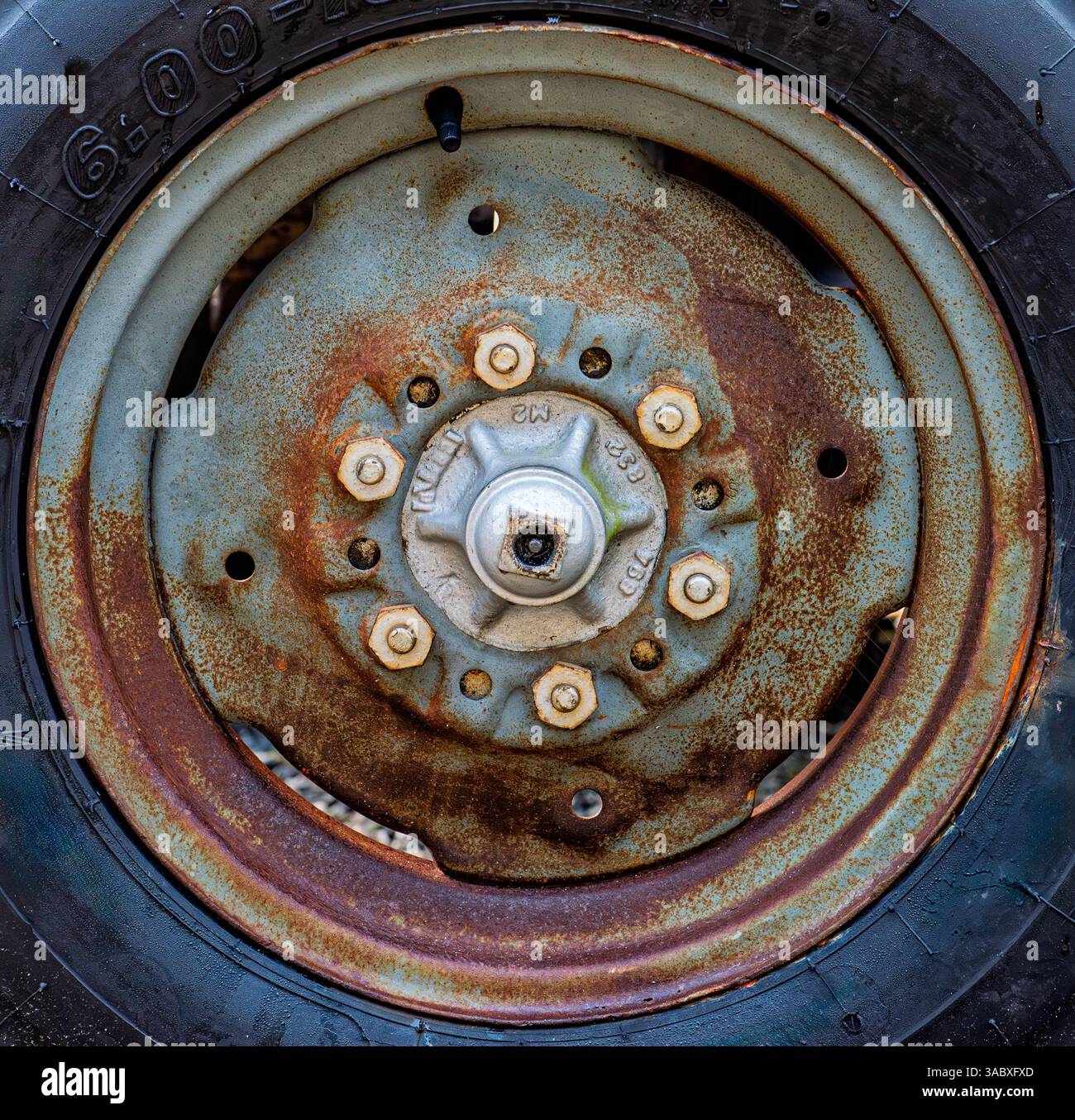 Close-up view of a rusty wheel rim with visible bolts and texture ...