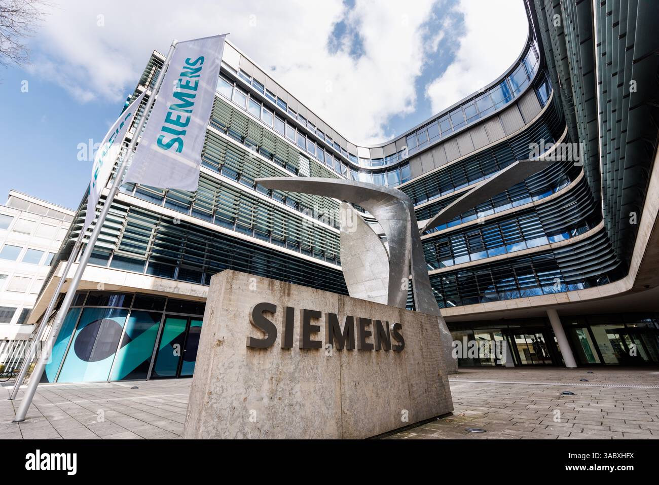 Munich, Germany. 02nd Apr, 2025. The lettering and logo of Siemens AG can be seen on flags in ...
