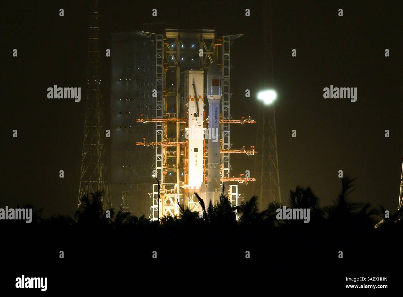Wenchang,China.30th March 2025. A Long March-7A rocket blasts off from ...