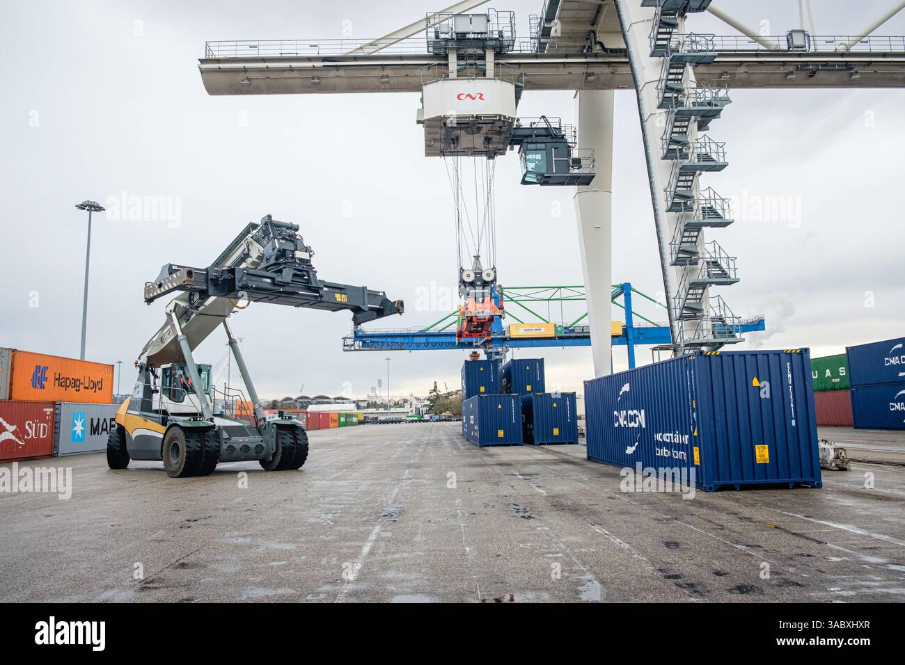 Loading containers with a container trolley at the Edouard Herriot port ...