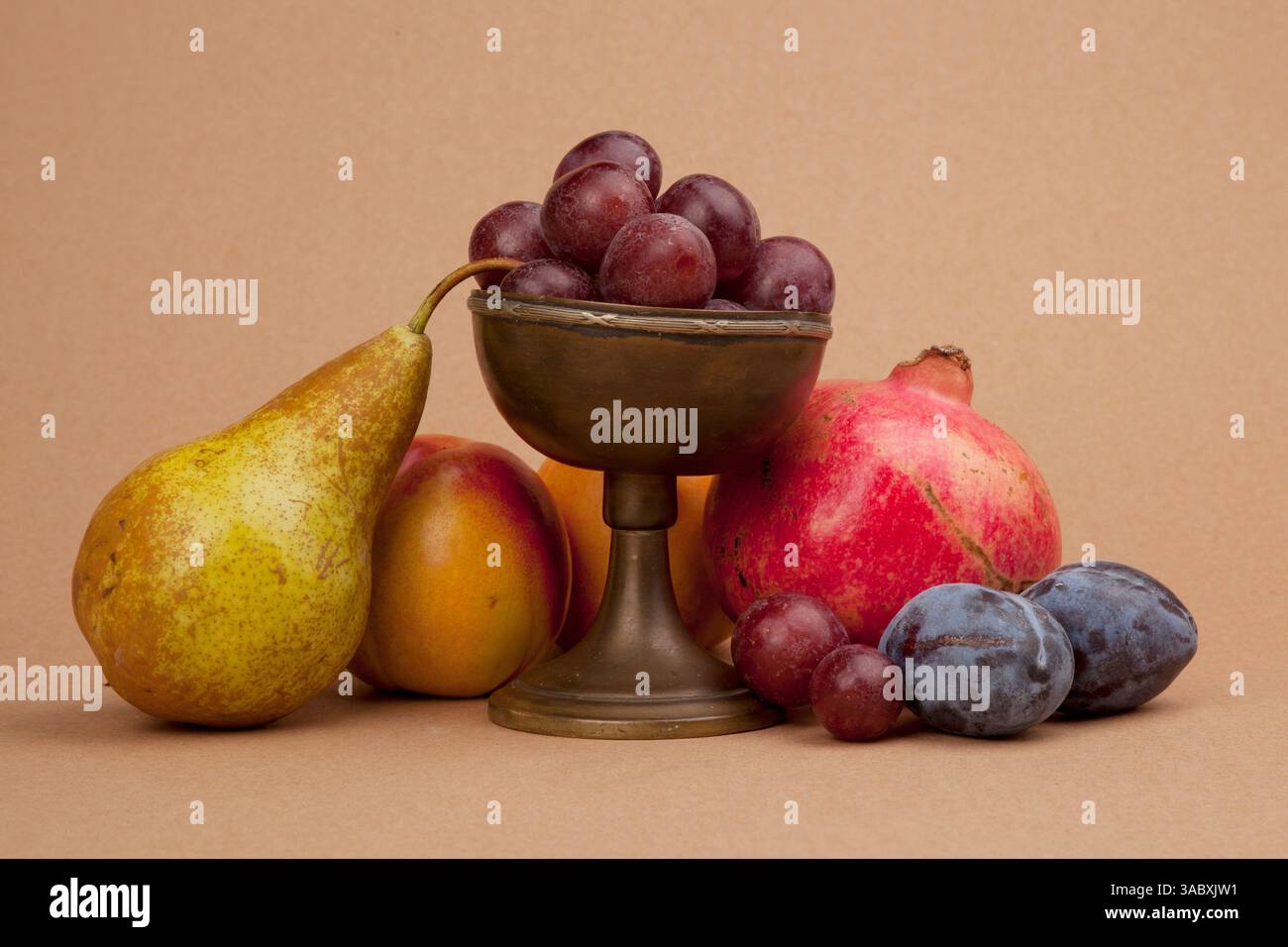 Arrangement of autunm fruits and an old cup Stock Photo - Alamy