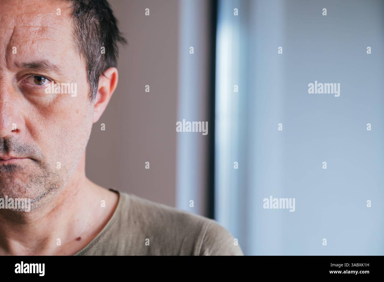 Half face portrait of serious mature adult caucasian male looking at ...