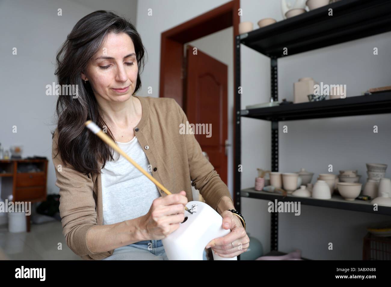 Spanish artist Olga Cuxart creats ceramic works in her studio ...