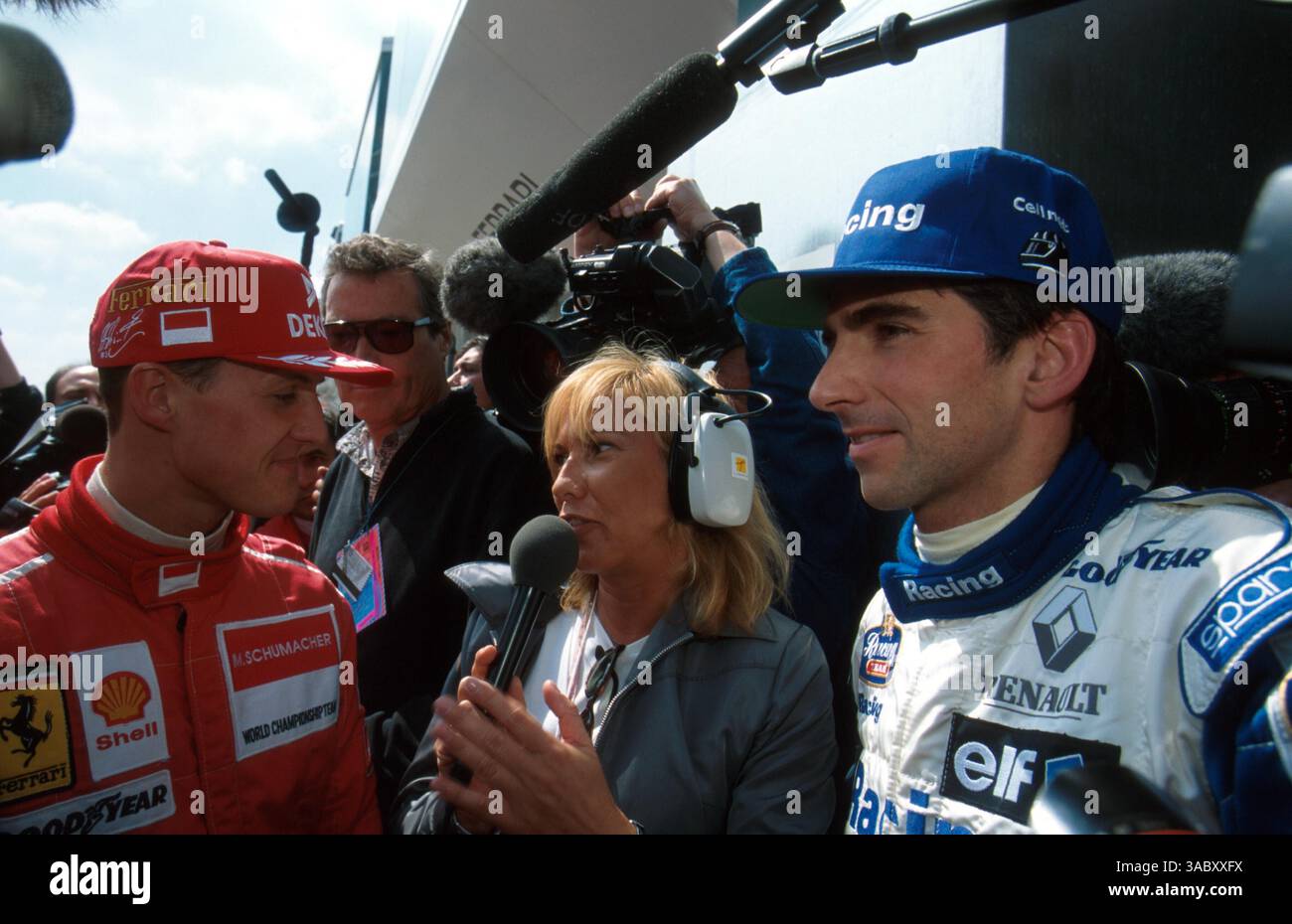 Michael Schumacher, left and Damon Hill interviewed by the media ...