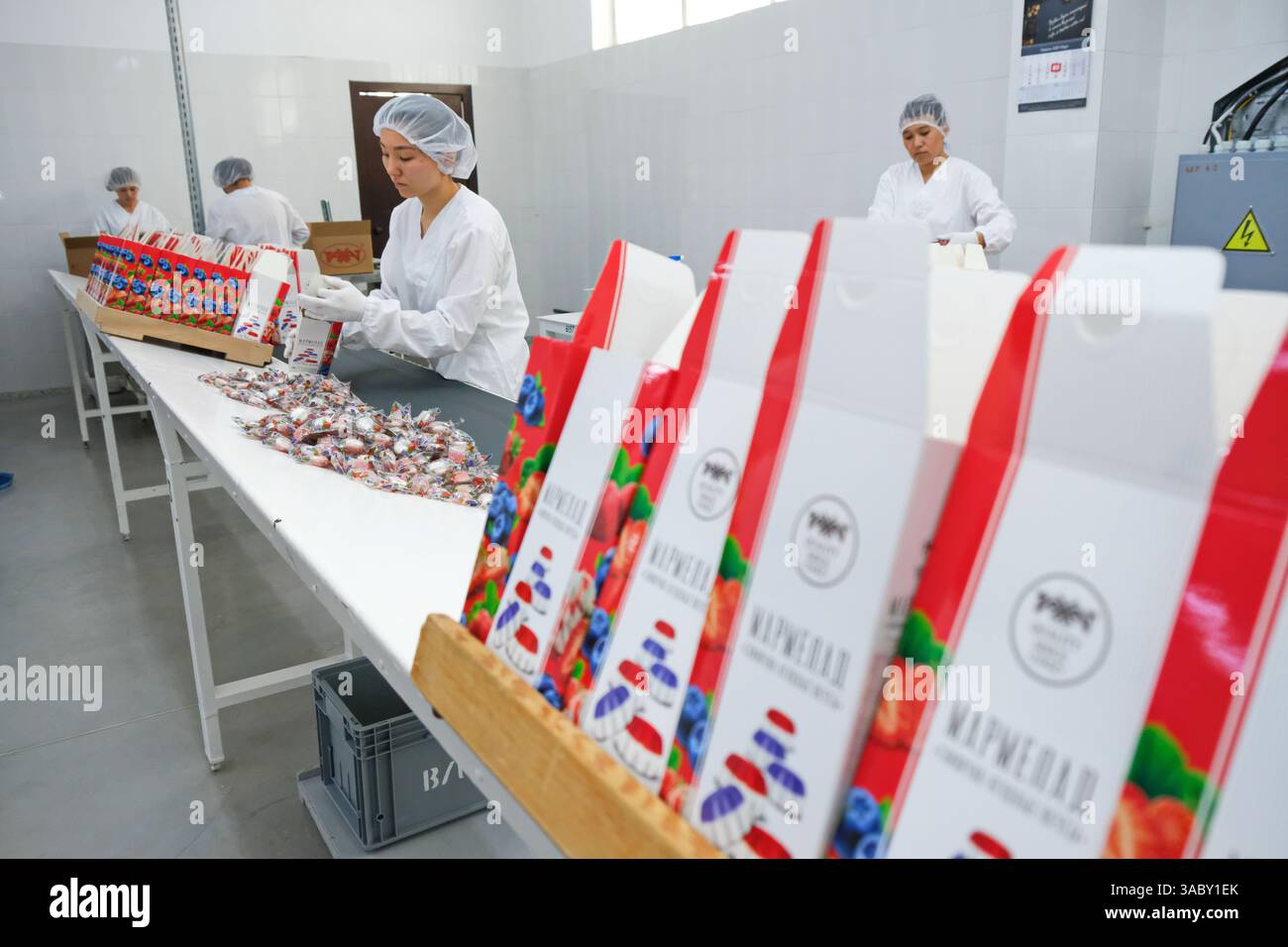Rakhat confectionery factory. Employees pack candy in branded boxes ...