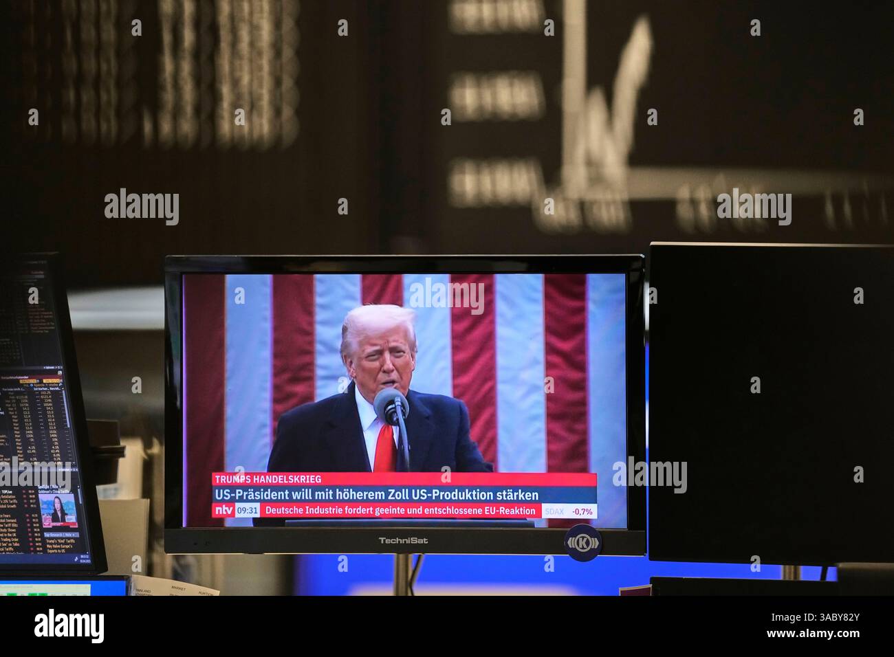 US President Donald Trump appears on a television screen at the stock ...