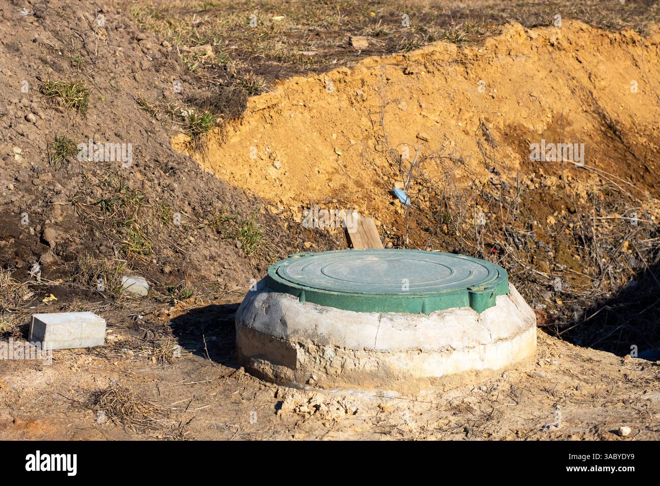A manhole cover is seen on a construction site, highlighting urban ...