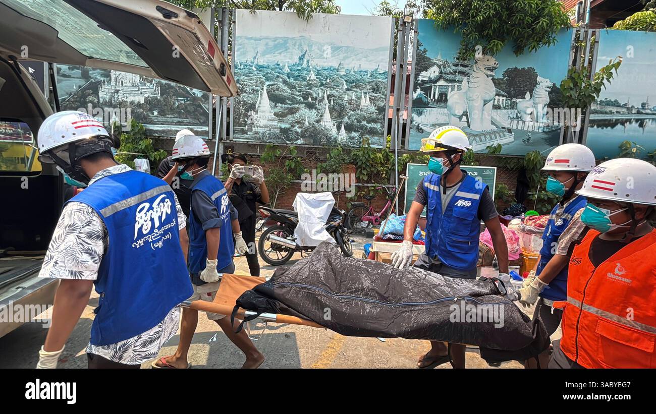Rescuers carry the body of a victim, from a collapsed building, in the ...