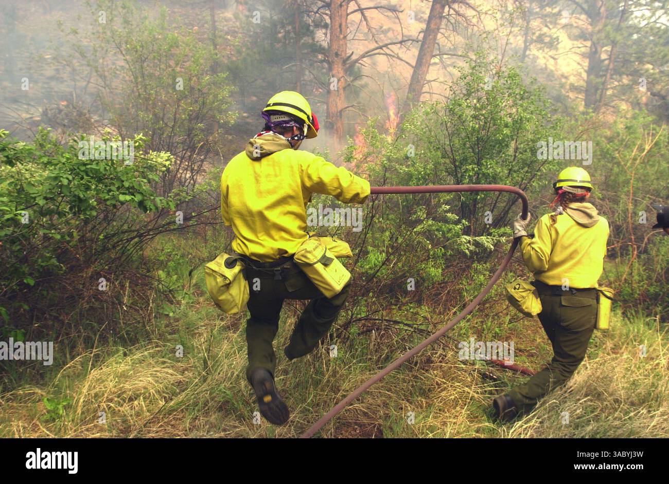 (PUBLISHED 06/13/2002, A-1): Firefighters KYLE RYAN, left, and SHERI ...