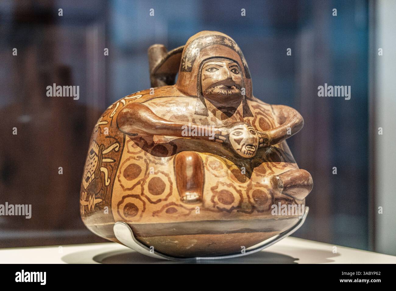 Vase with a bridge handle depicting a human figure carrying a trophy ...