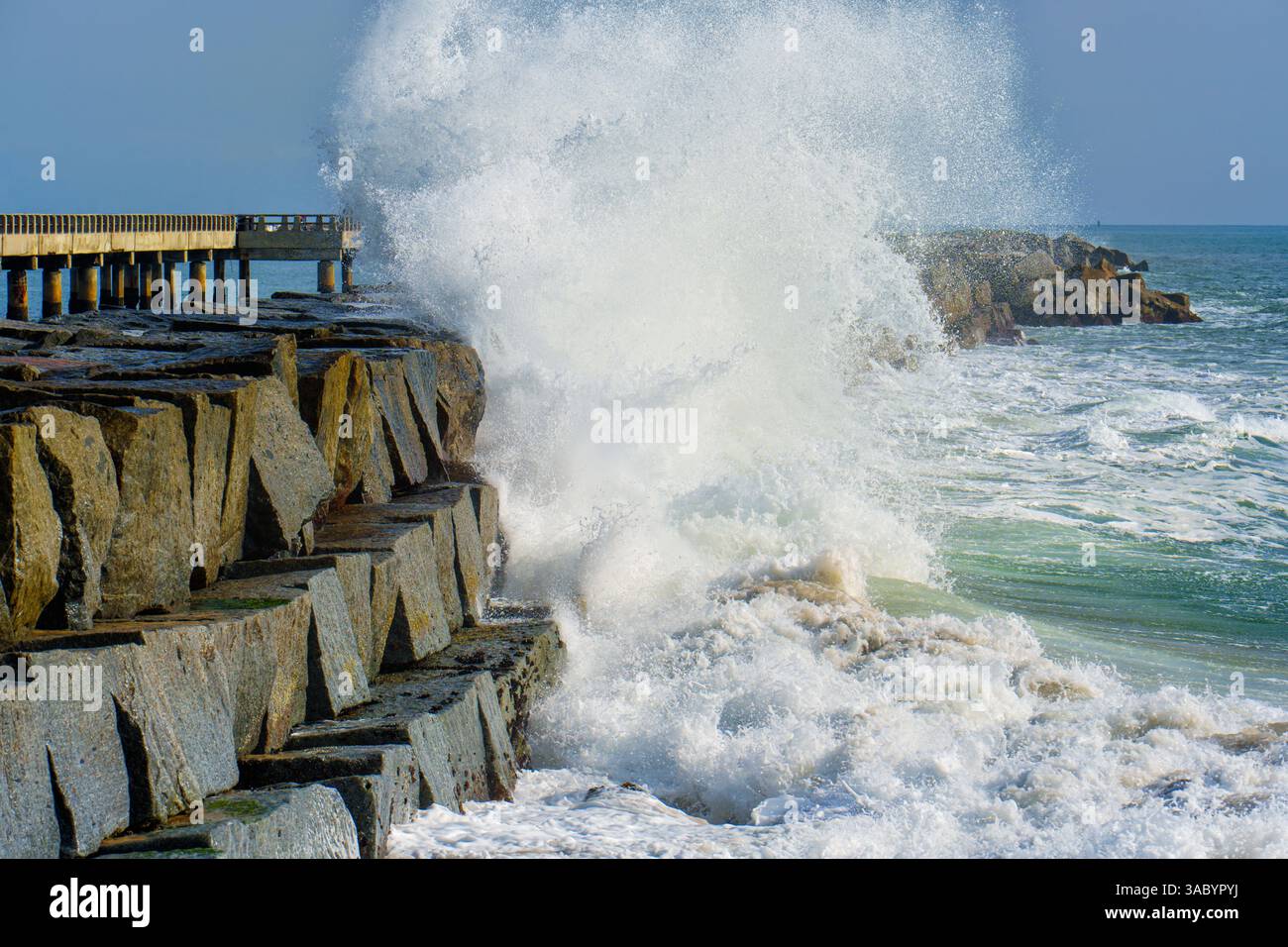 Rugged rock formations are drenched by powerful ocean waves crashing at ...